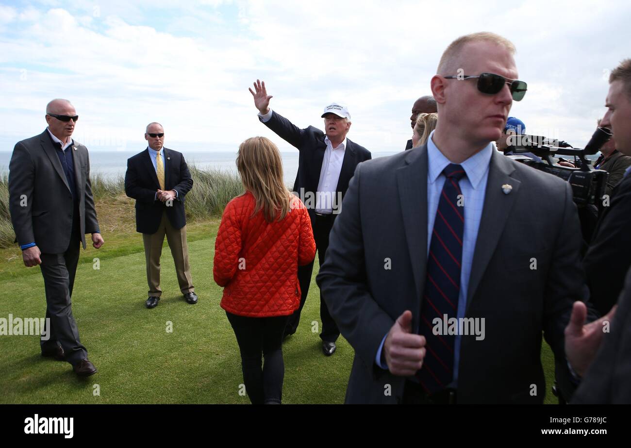 Security watch Donald Trump (centre0 chat on the 14th tee with the ...