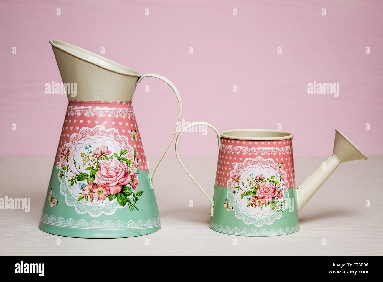 Simple colorful metallic watering cans on pink background Stock Photo ...