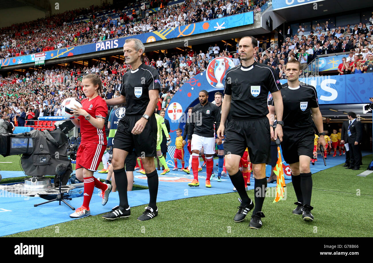 Referee Martin Atkinson (left) leads the two teams out for the match ...