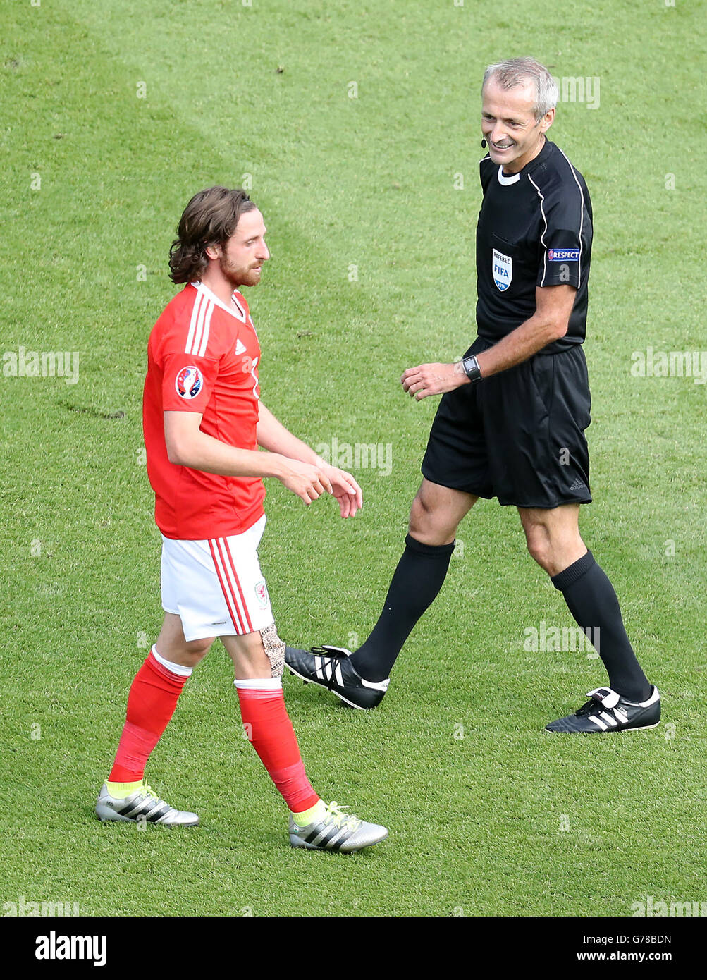 Wales' Joe Allen (left) and Referee Martin Atkinson during the round of ...