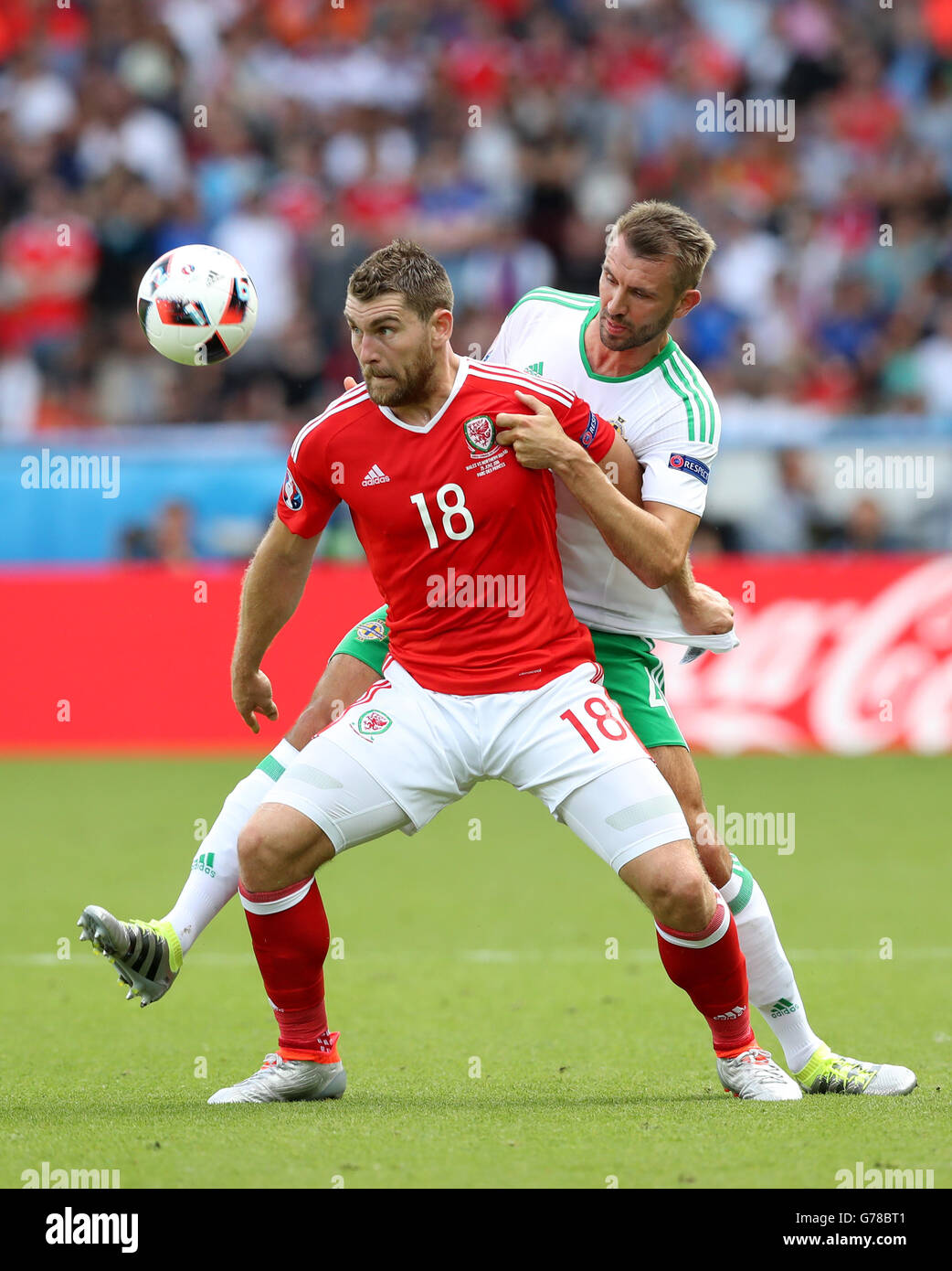 Wales' Sam Vokes (left) and Northern Ireland's Gareth McAuley (right ...