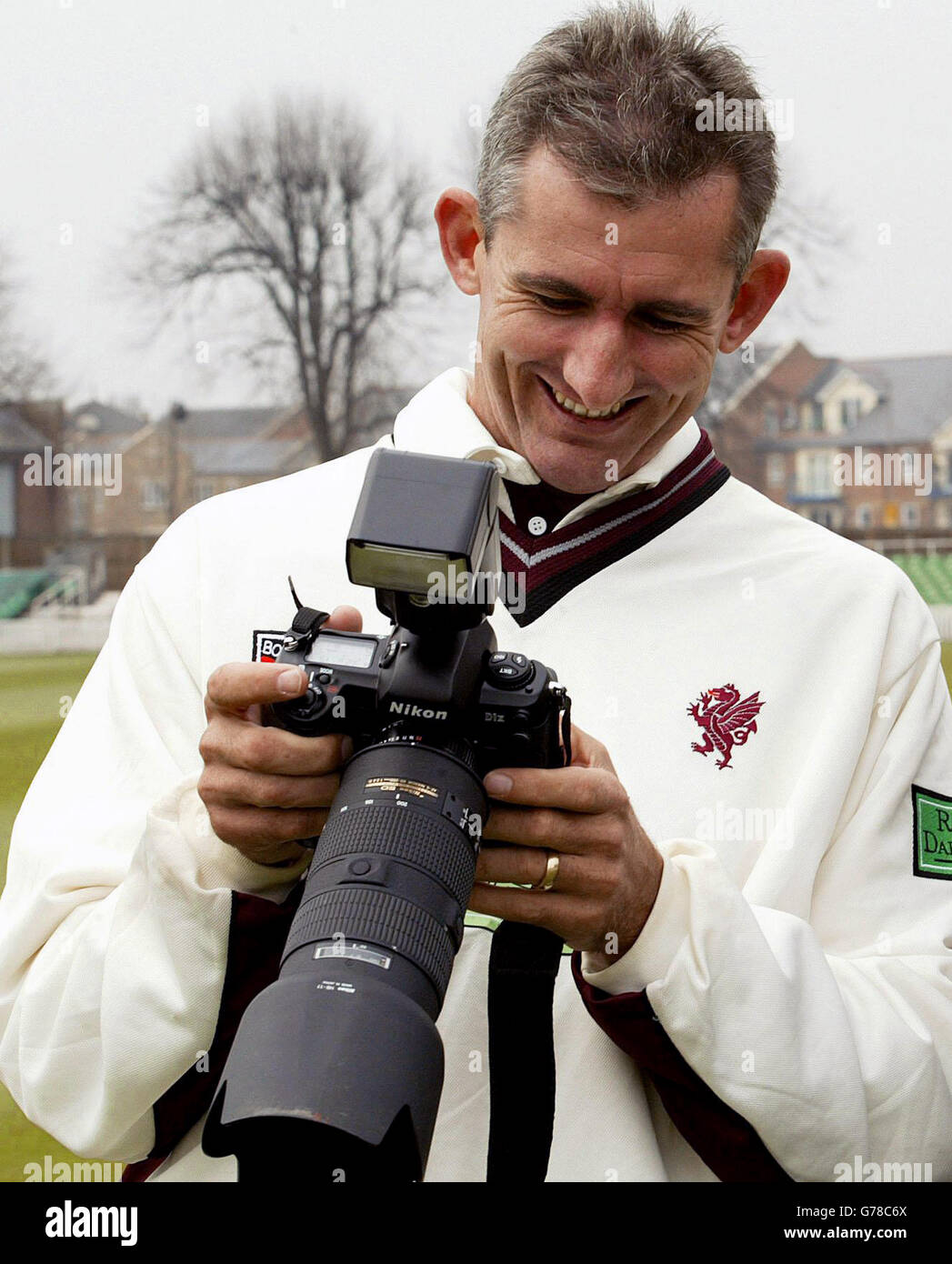 England fast bowler Andrew Caddick plays with a press camera during a ...