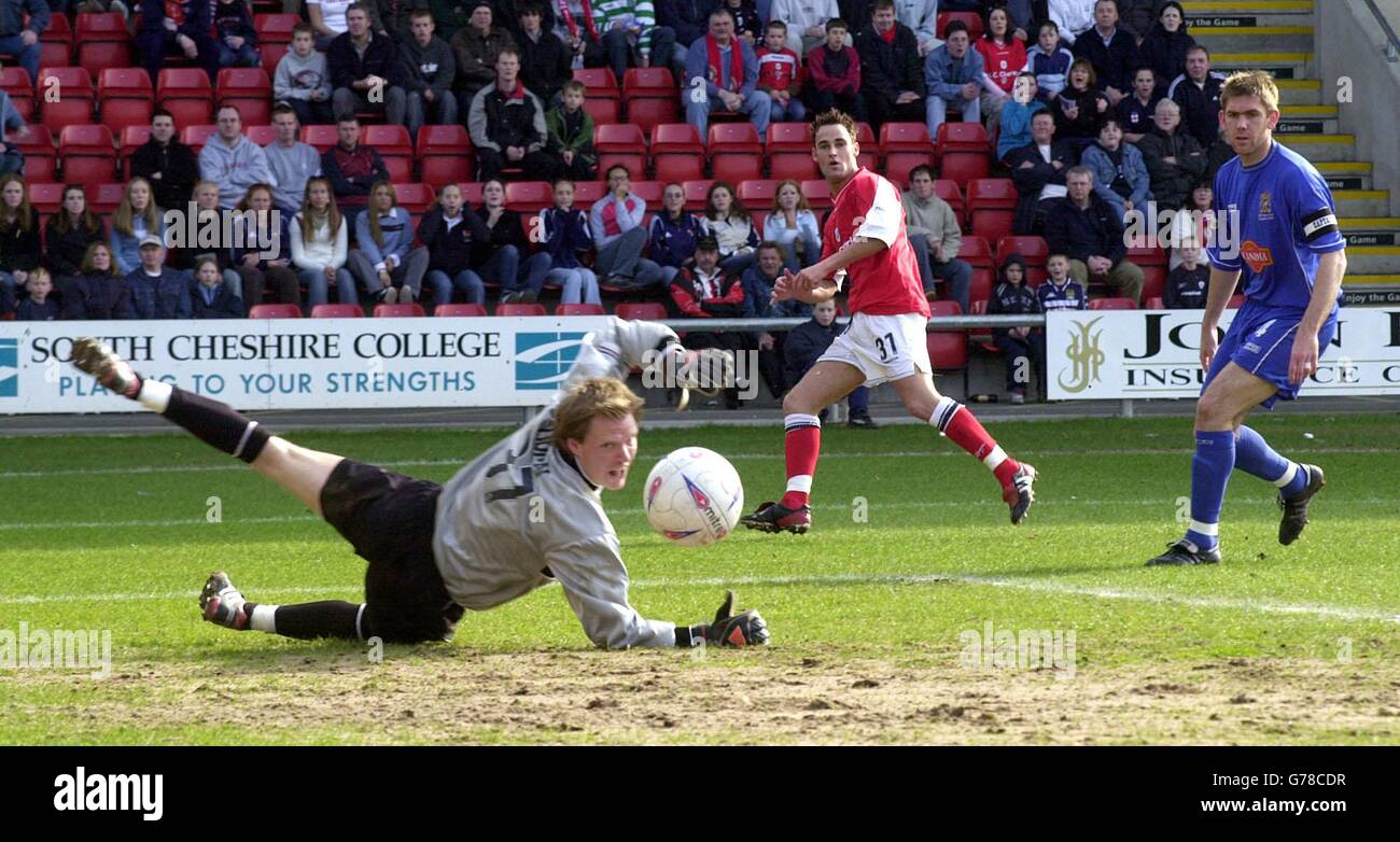 Crewe's Stefan Oakes (centre) shoots the ball wide of the goal, past ...