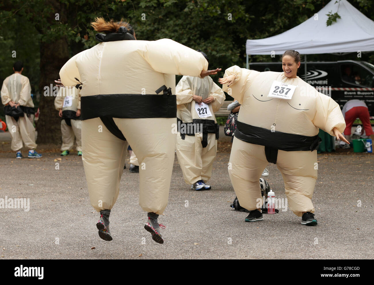 5km charity fun run runners wearing inflatable sumo suits hi-res stock ...