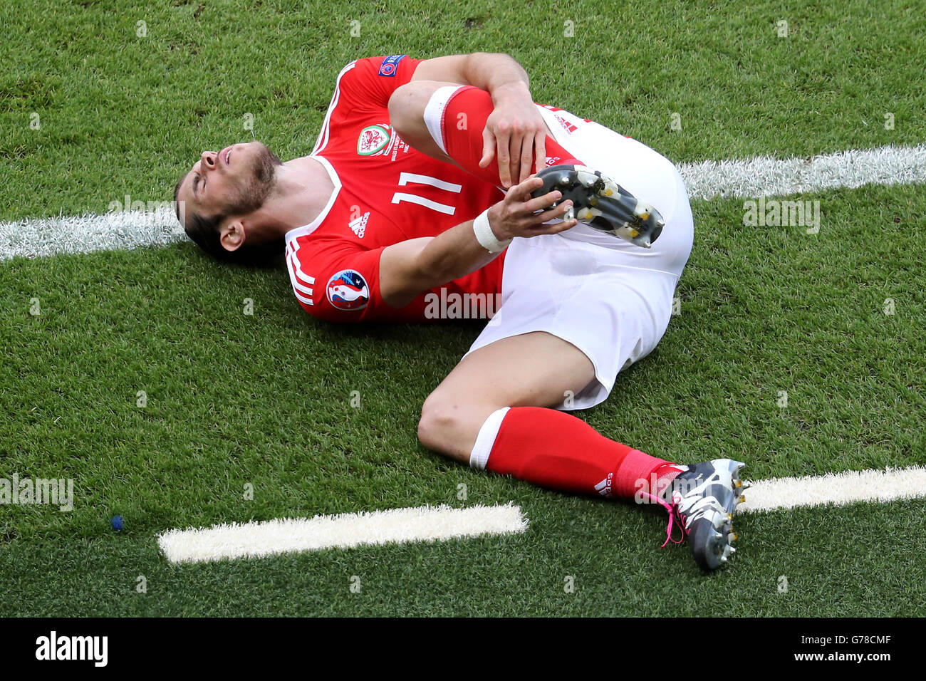 Wales' Gareth Bale holds his foot after a tackle by Northern Ireland's ...