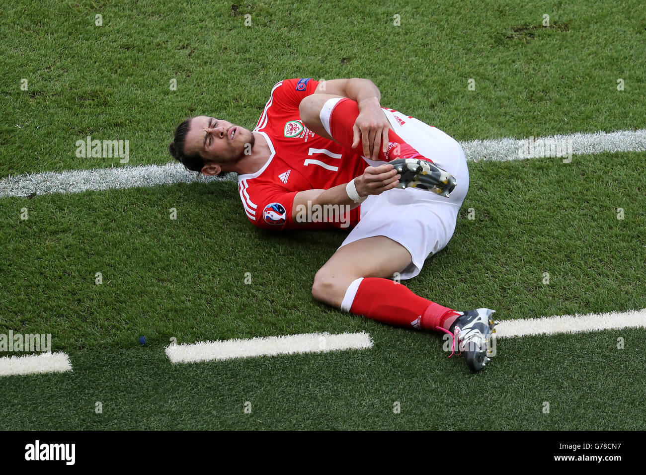 Wales' Gareth Bale holds his foot after a tackle by Northern Ireland's ...