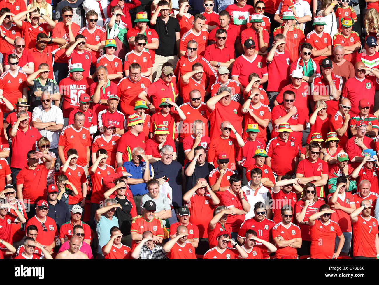 Wales supporters shield their eyes from the sun in the stands during ...