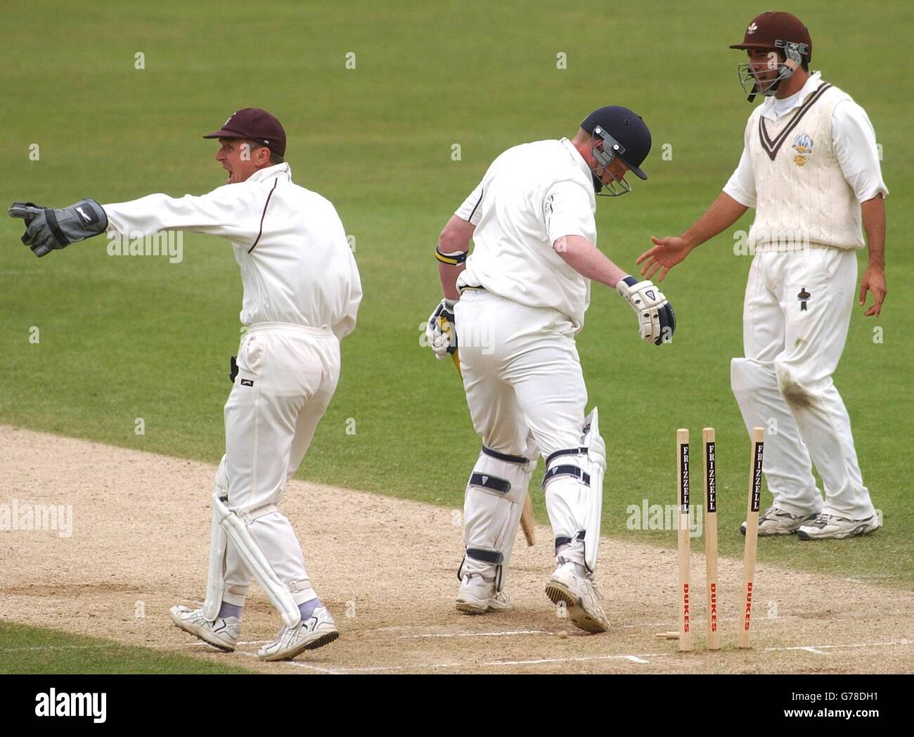 Dominic Ostler of Warwickshire (centre) survives a stumping attempt by ...
