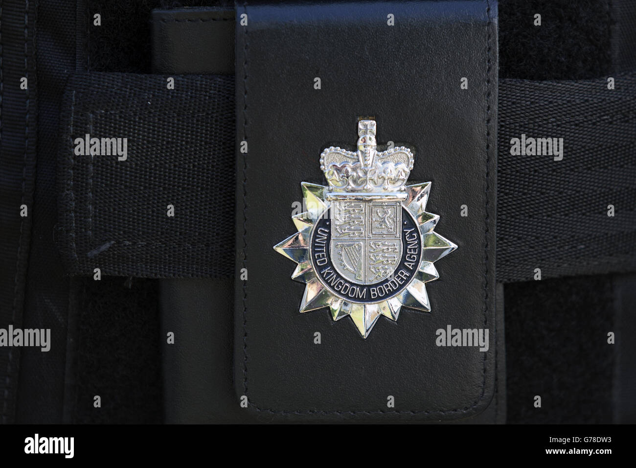 A UK Border Agency crest on the uniform of a Home Office Immigration ...