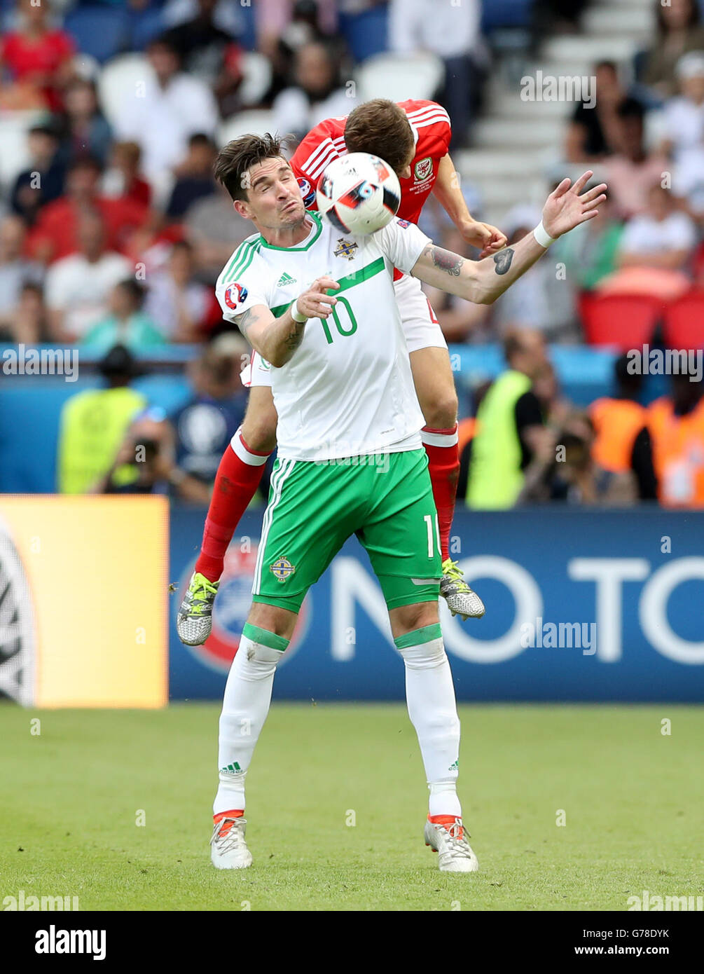 Wales' Ben Davies (top) and Northern Ireland's Kyle Lafferty battle for ...