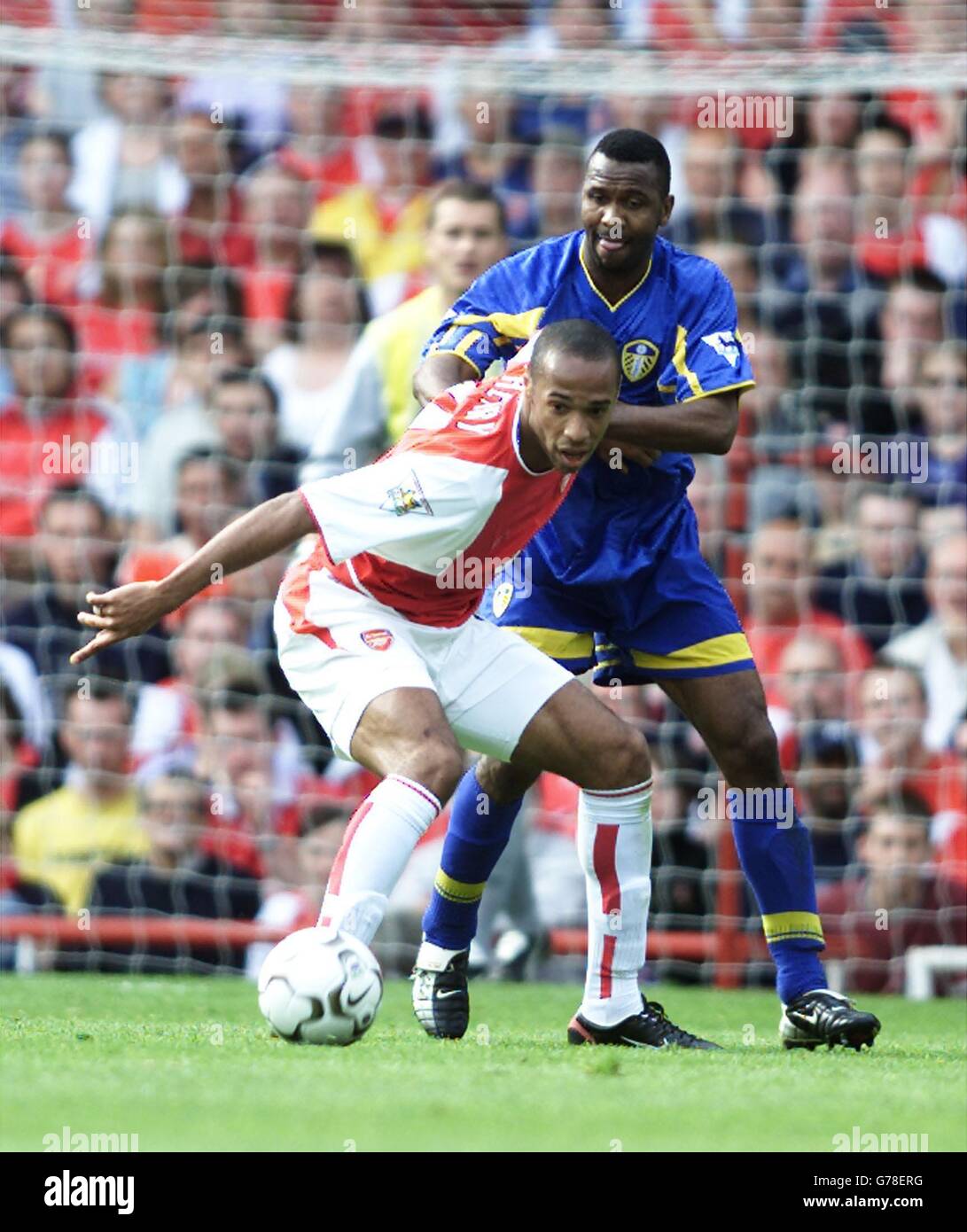 Arsenal's Thierry Henry (front) and Leeds United's Lucas Radebe during ...