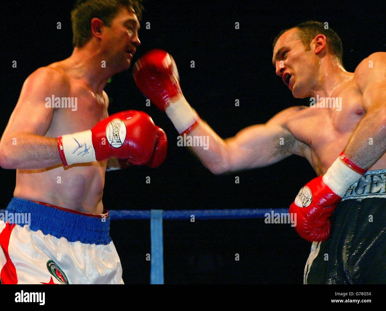 Brian Magee (black shorts) takes on Andre Thysse for the IBO Super-Middleweight Championship of ...