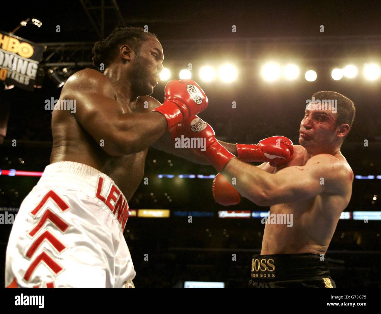 Cut Vitali Klitschko (right) exchanges blows with Lennox Lewis during ...