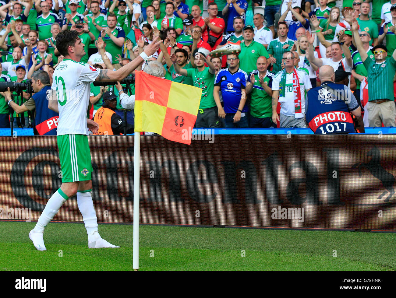 Northern Ireland's Kyle Lafferty throws his boots to the fans after the ...