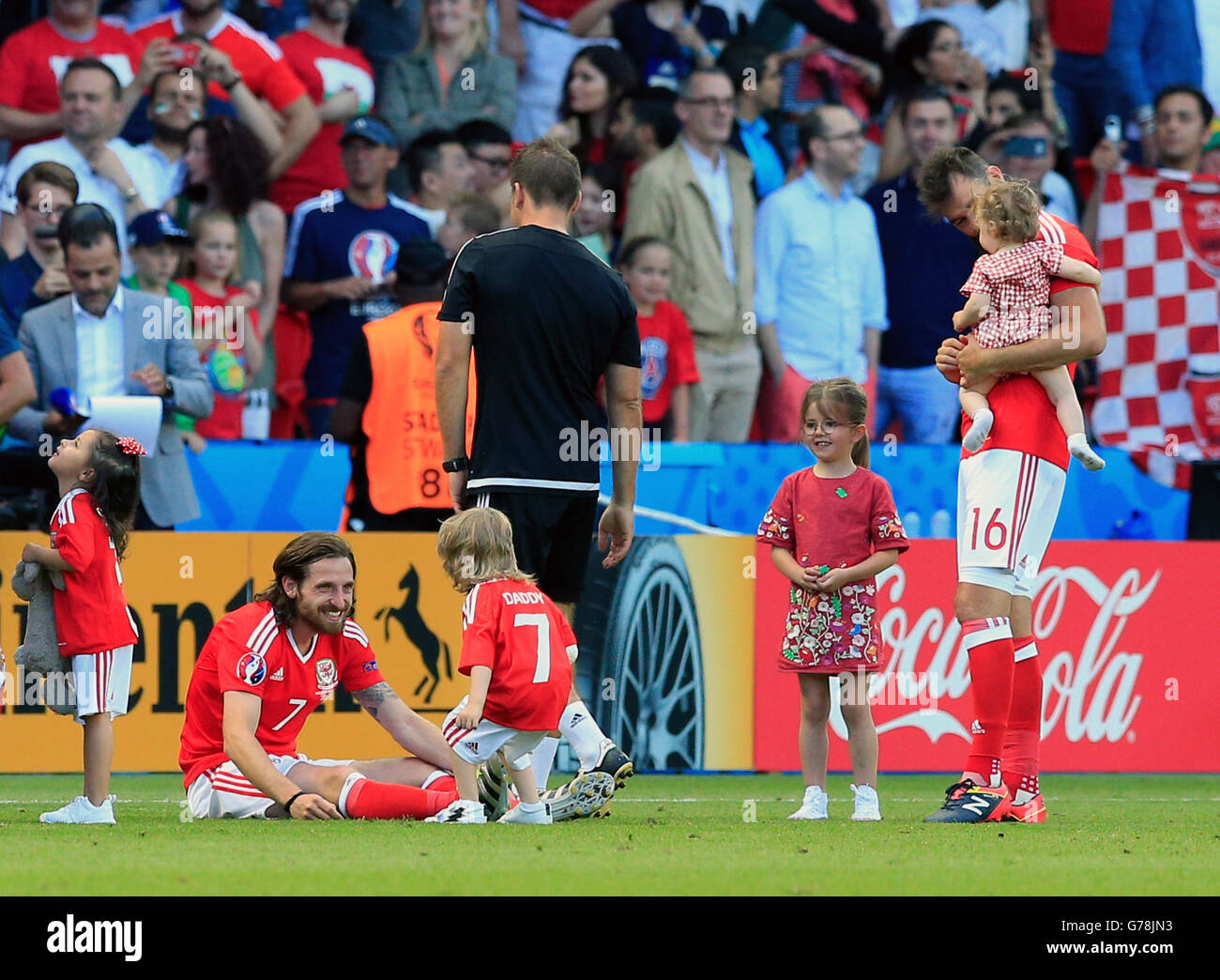 Wales' Joe Allen celebrates with his children after the final whistle ...