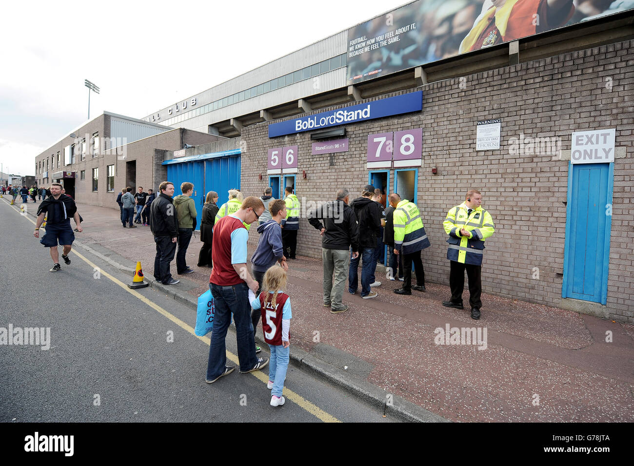 Fans queue to go through the turnstiles before the match Stock Photo ...