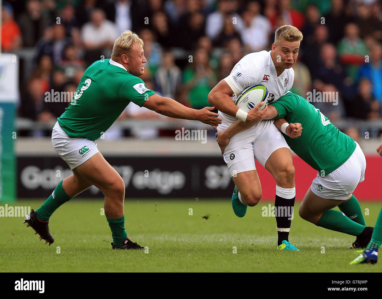 Ireland's Ben Betts (left) and Adam McBurney tackle England's Harry ...