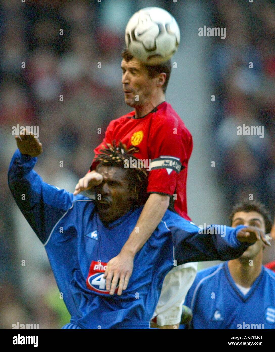 Manchester United's Roy Keane climbs above Aliou Cisse of Birmingham ...