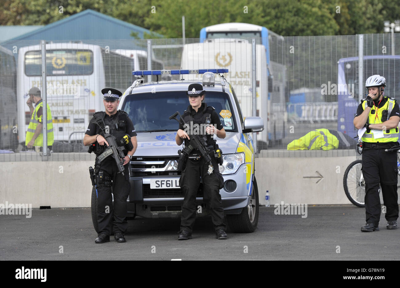 Armed Police Officers patrol a gate at the Athletes Village as security ...
