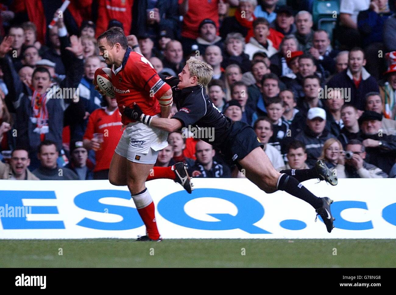 Munster's Rob Henderson has the strength to run through a tackle by ...