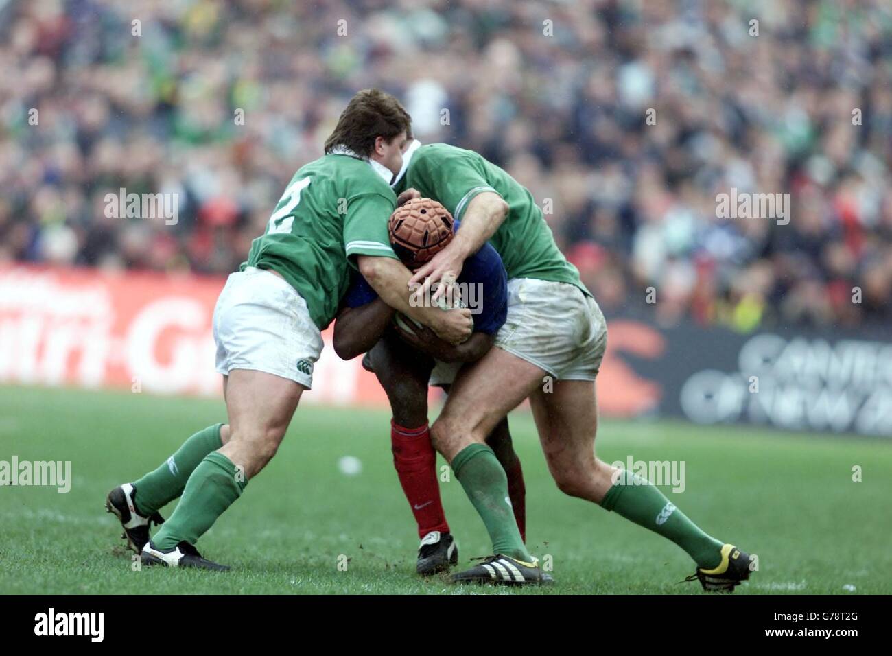 Ireland's James Byrne (L) and Gary Longwell tackle France's Serge ...
