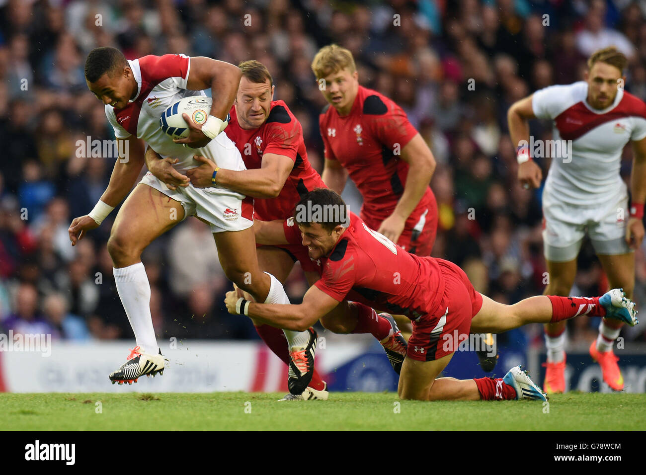 England's Marcus Watson is tackled by Wales' Luke Morgan and Gareth ...