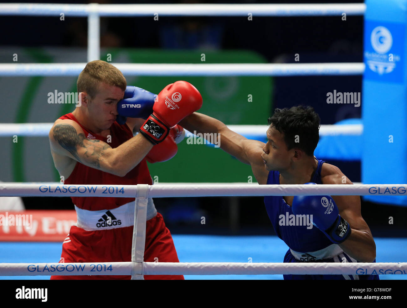 Cyprus' Ploutarchos Parris (red) in action against Malaysia's Khir ...