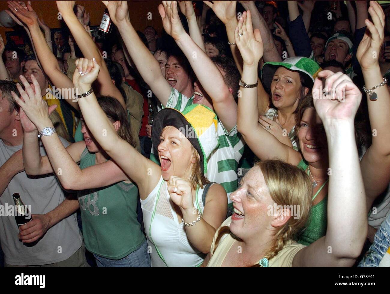 Celtic fans in a Glasgow bar celebrate as their team equalize hold ...