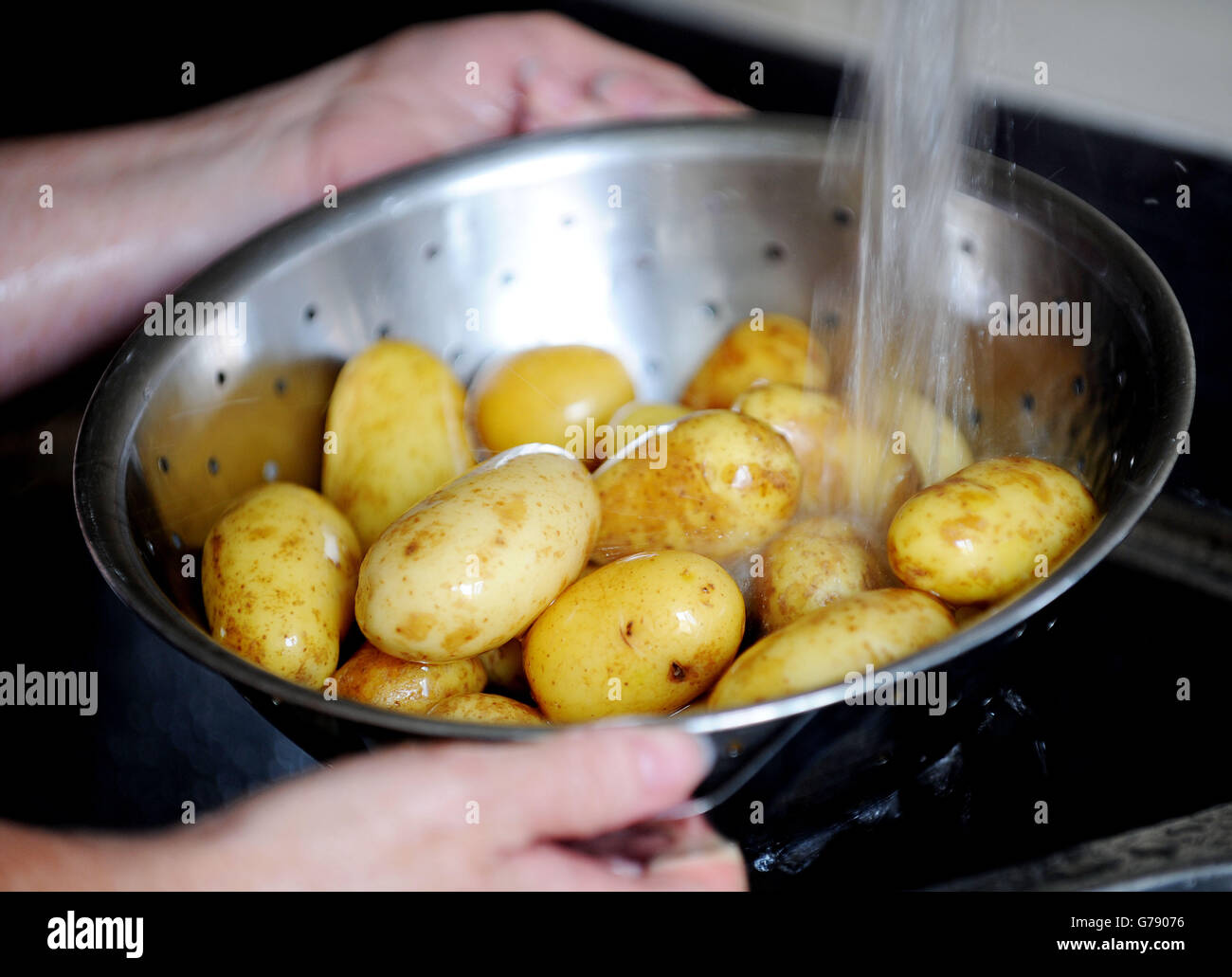 Vegetable stock photo of baby new potatoes being washed in a colander ...