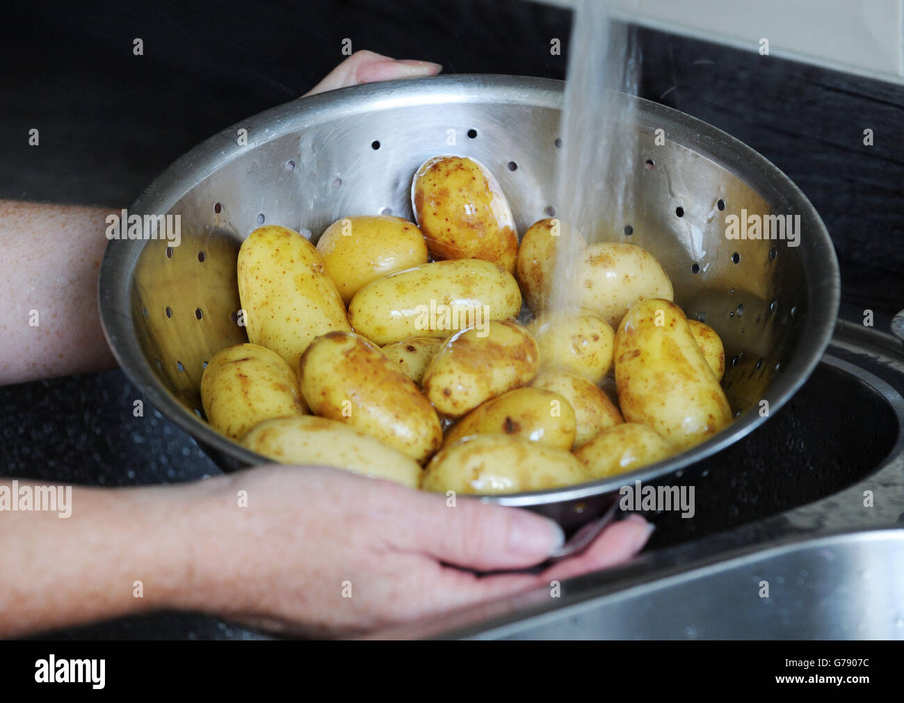Vegetable stock photo of baby new potatoes being washed in a colander ...