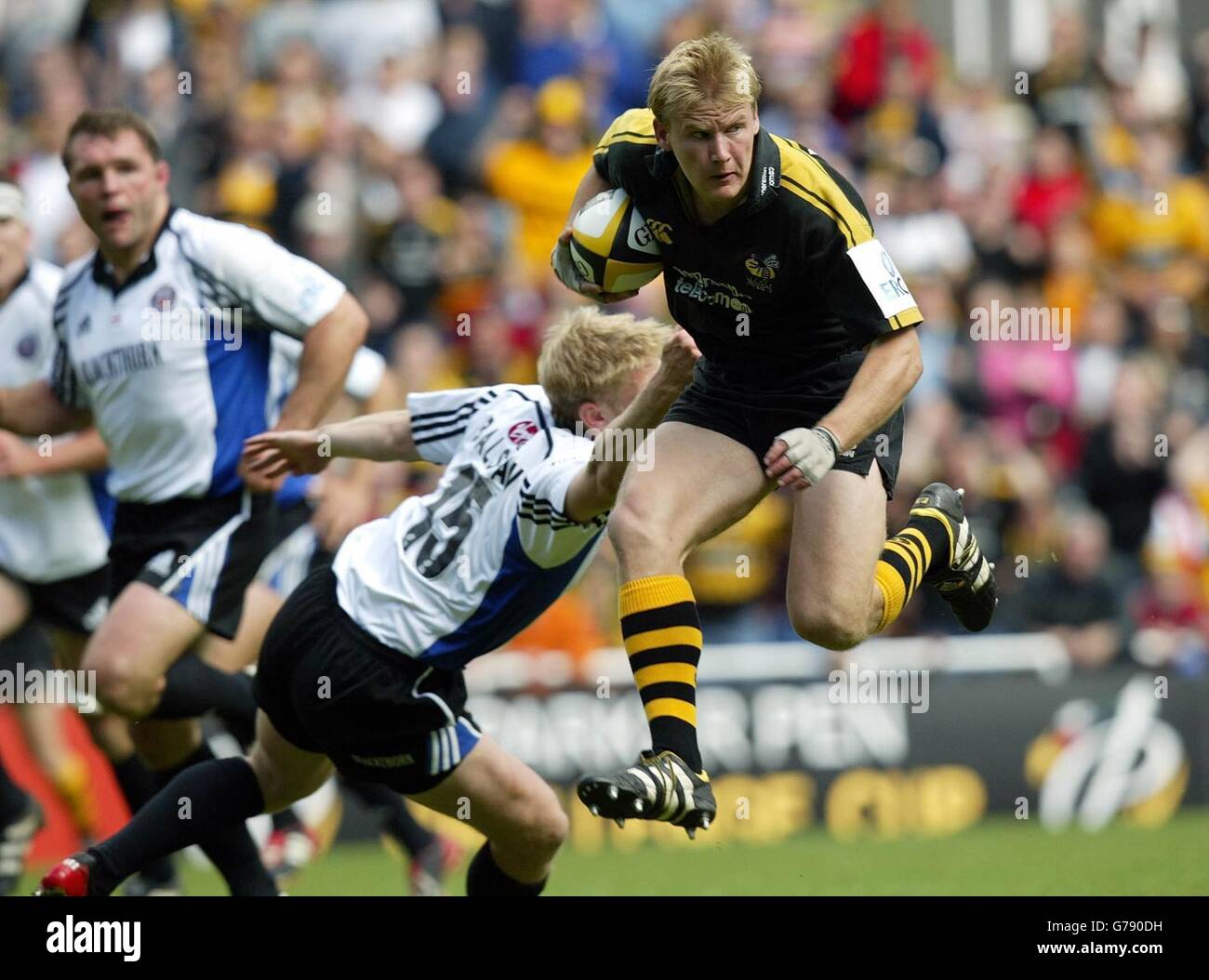 Stuart Abbott of Wasps breaks through the tackle of Bath's Iain Balshaw ...