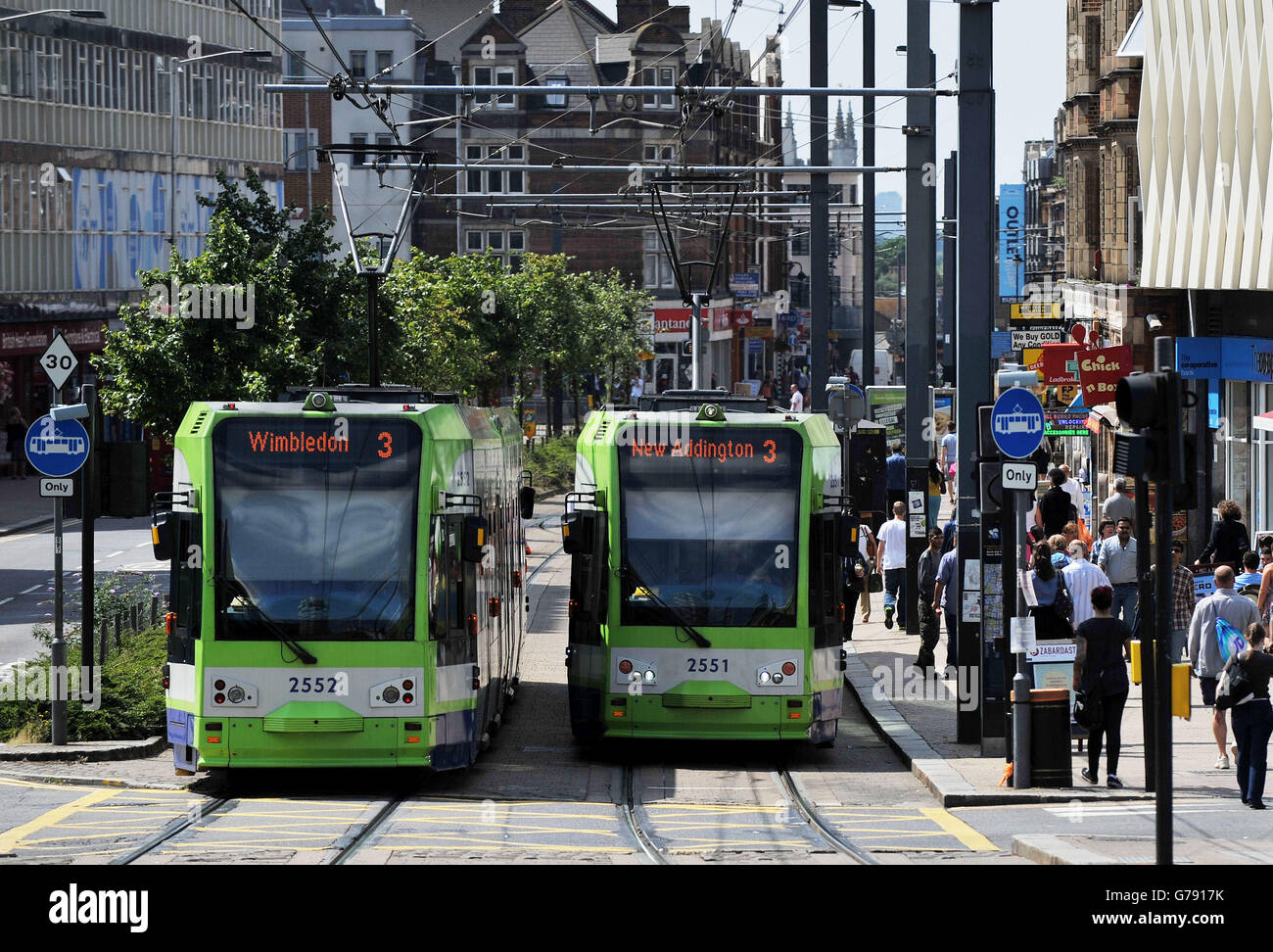 Croydon tram - stock. Tramlink trams pass each other along George ...