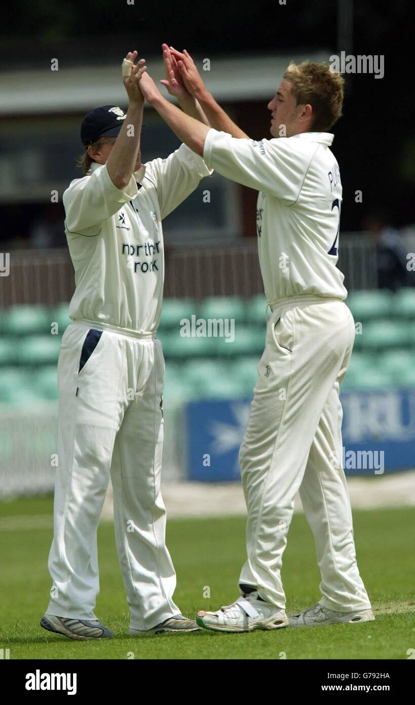 Durham's Plunkett (right) celebrates claiming the wicket of ...