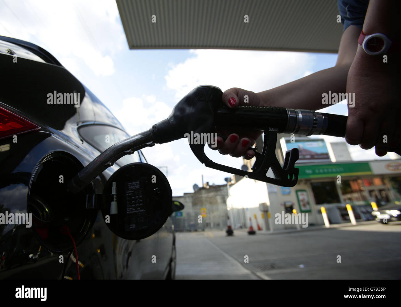 A car being filled up with a pump at a petrol station in London Stock ...