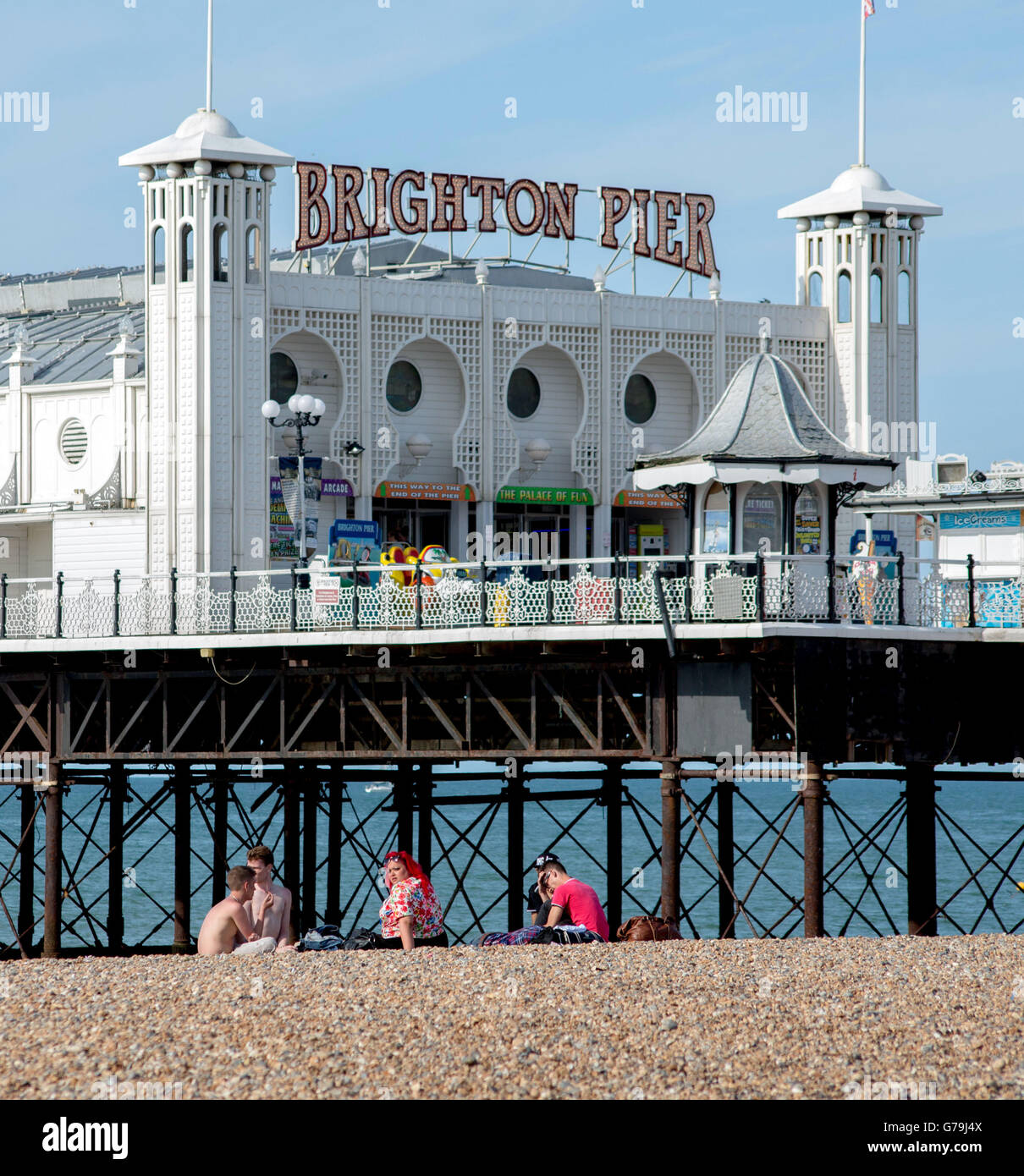 People enjoy the early morning sunshine on the beach in Brighton ...
