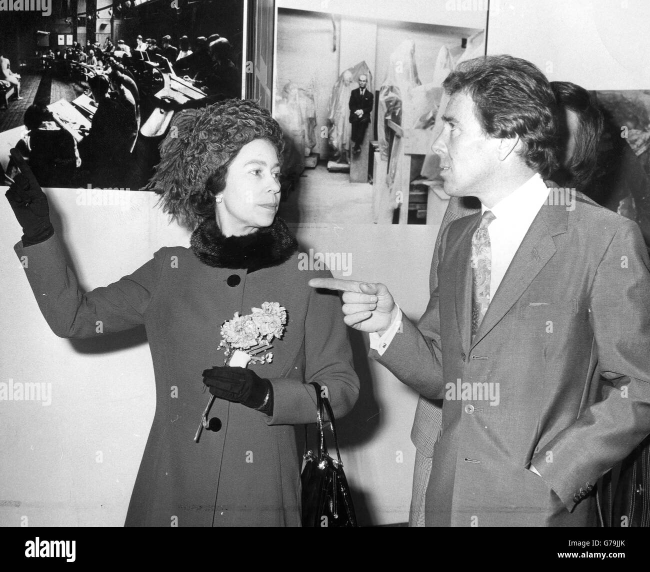 Queen elizabeth ii discusses photograph with lord snowdon at olympia hi ...