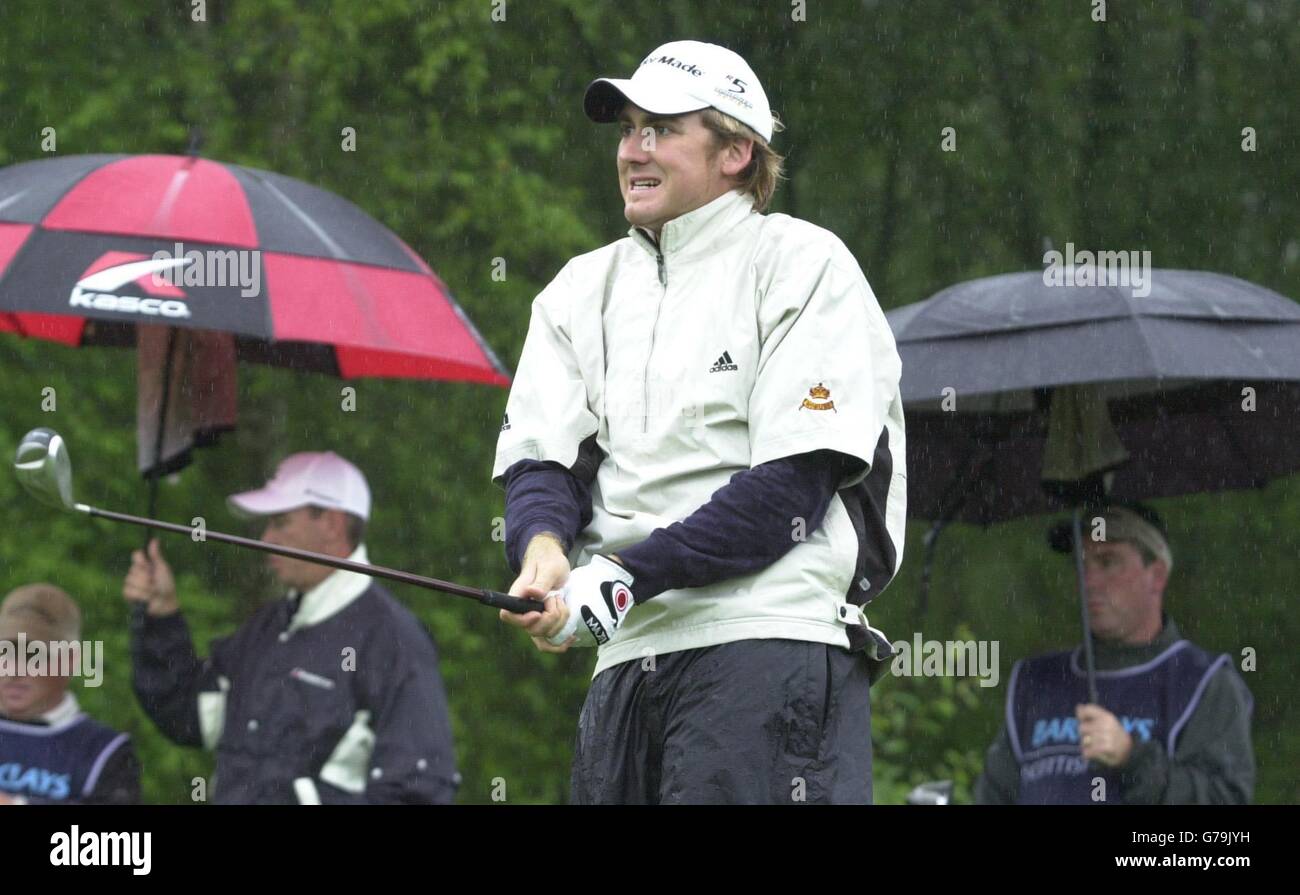 England's Ian Poulter takes a shot on the eleventh hole as the rain ...