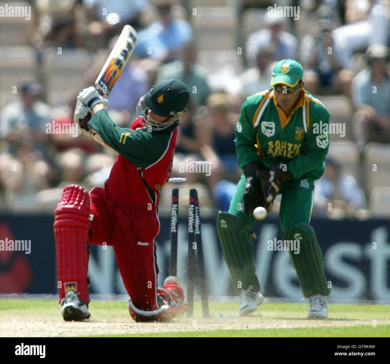 Zimbabwe's Andy Blignaut is bowled by South Africa's Paul Adams during ...
