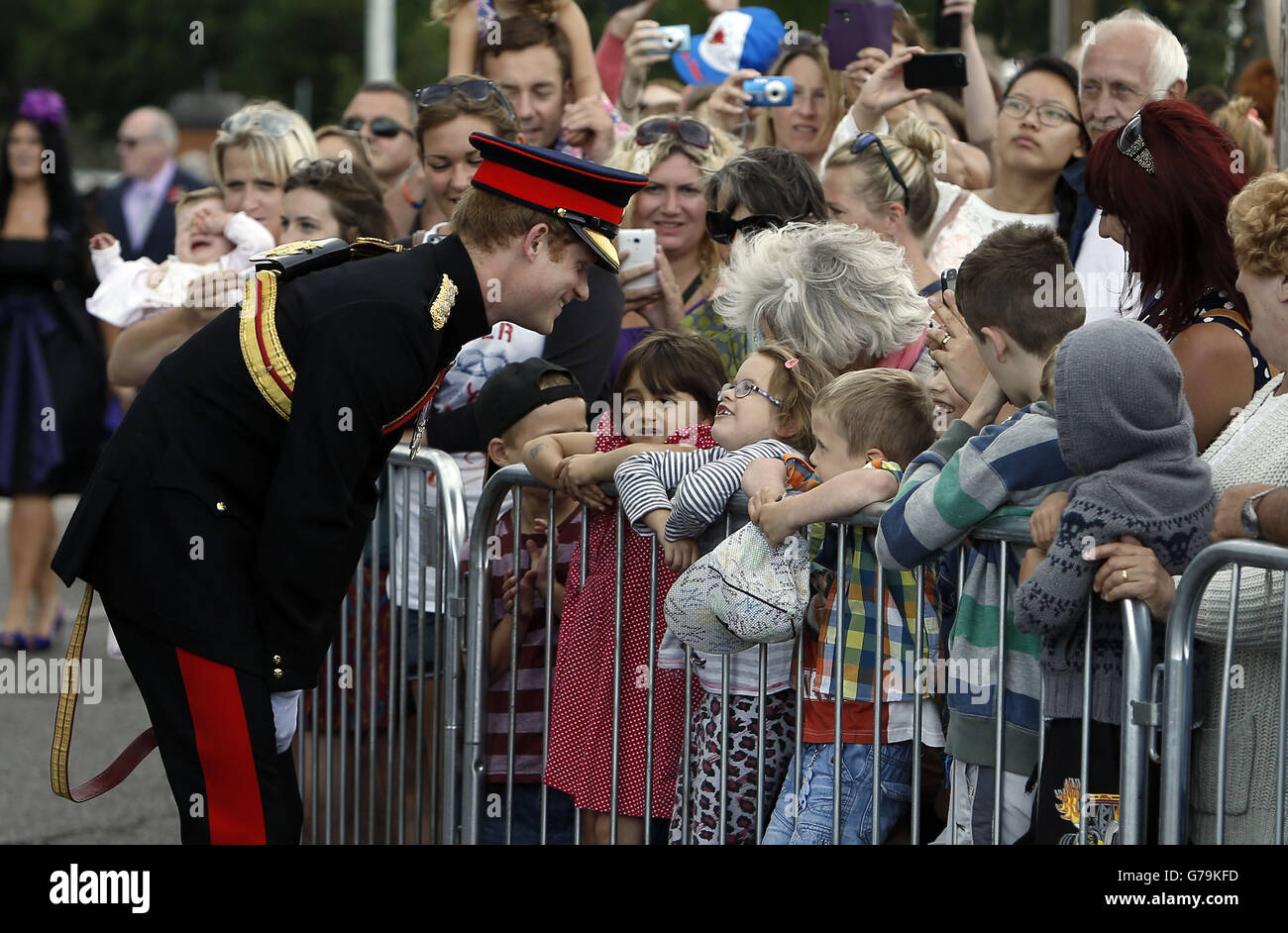 Prince Harry talks with 6-year-old Kelisha Marsh (centre with glasses ...