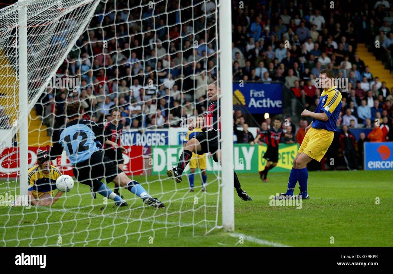 Stephen Caffrey from Bohemians (red & black) scores in their match ...