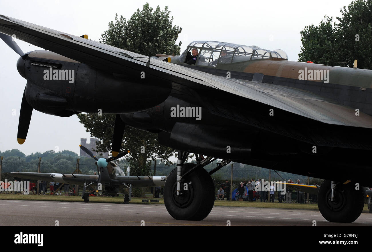 Enthusiasts watch a Lancaster from the Royal Air Battle of Britain ...