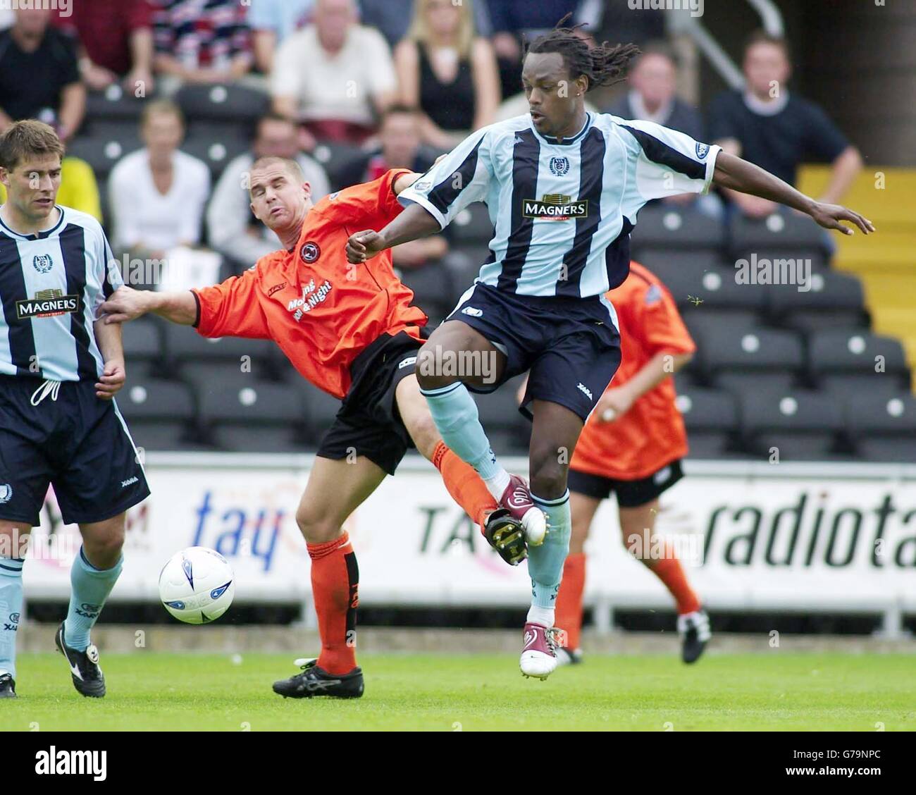 Alan Archibald of Dundee United (second left) challenges for the ball ...