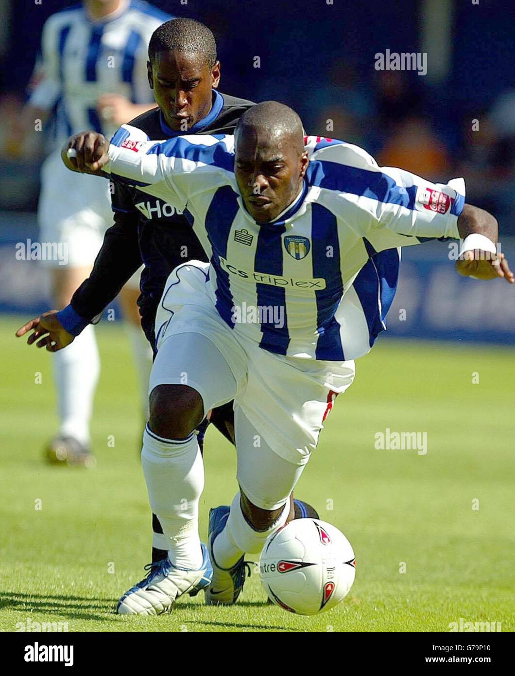 Colchester United's Wayne Andrews (stripes) is challenged by Adam ...
