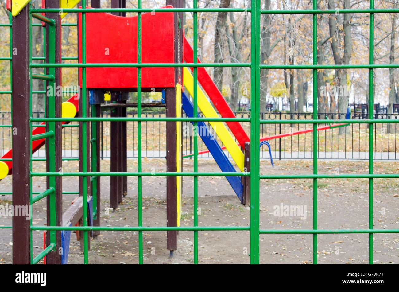 An empty playground in the park against the backdrop of autumn trees ...