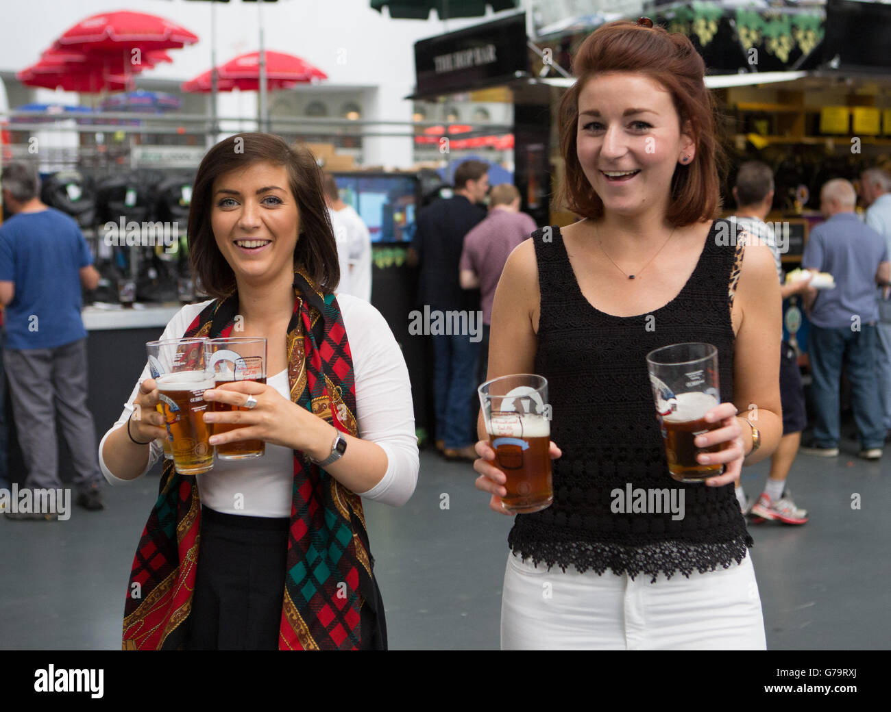 Girls carrying beer at the Great British Beer Festival at Olympia ...