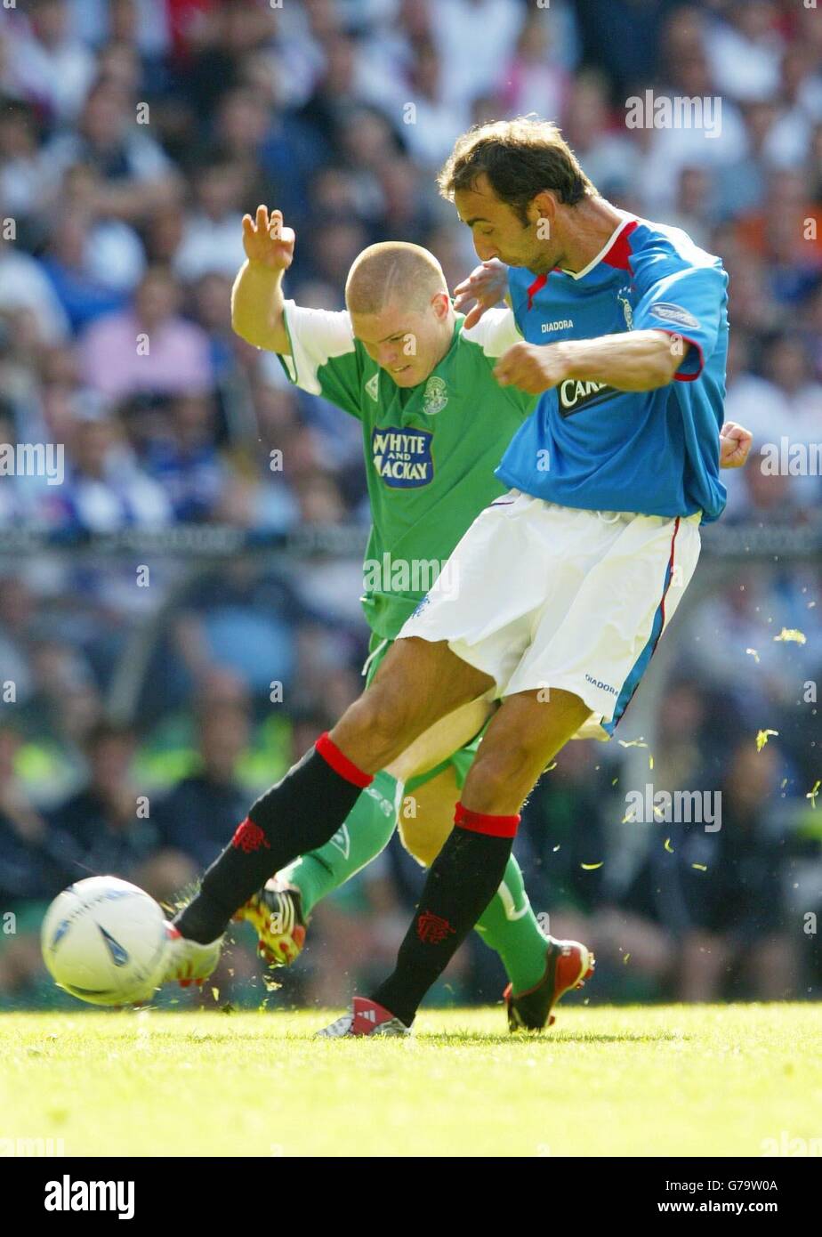 Rangers' Dragan Mlandenovic (R) tussles with Hibernian's Dean Shields ...