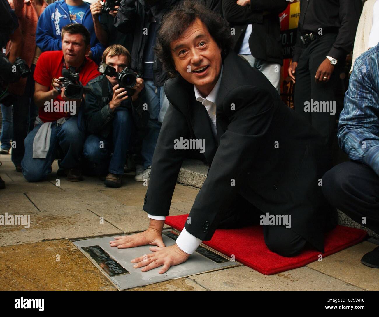 Led Zeppelin guitarist Jimmy Page creates hand prints outside the ...