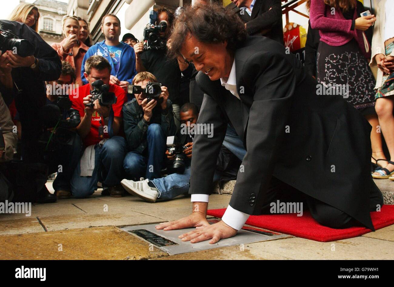 Led Zeppelin guitarist Jimmy Page creates hand prints outside the ...