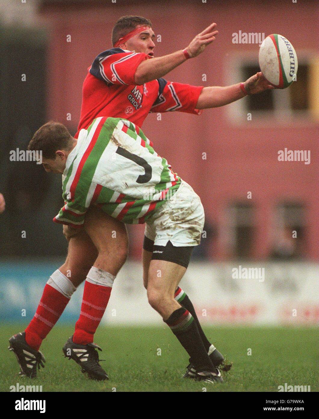 Llanelli's Stephen Ford loses the ball as Leicester Tigers' Rob Liley ...