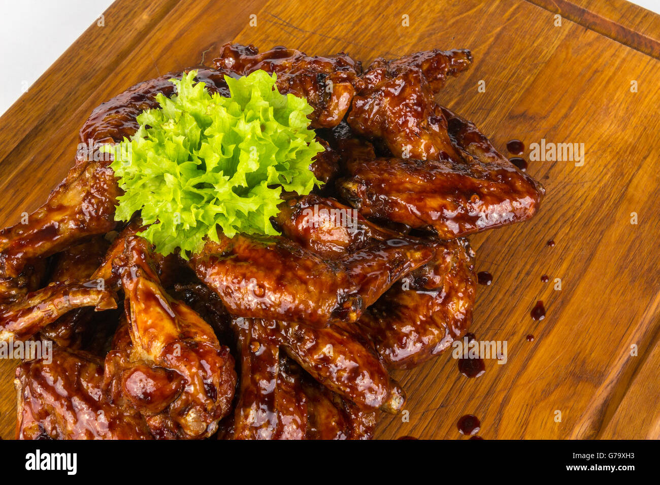 many chicken wings in hot sauce on wooden desk Stock Photo - Alamy